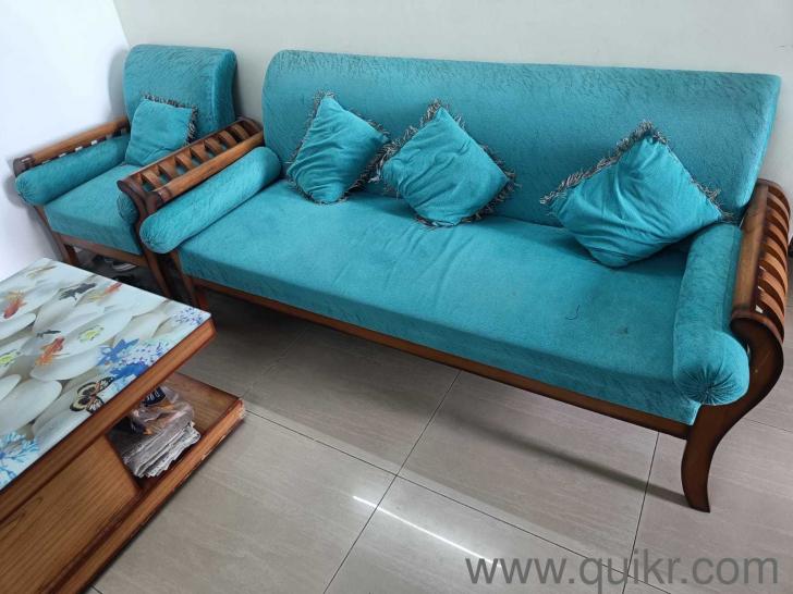 5 seater wooden sofa with centre table and glass on top of centre tabel ...